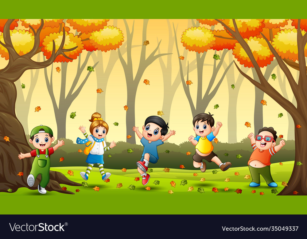 Children playing with fallen leaves in autumn fore