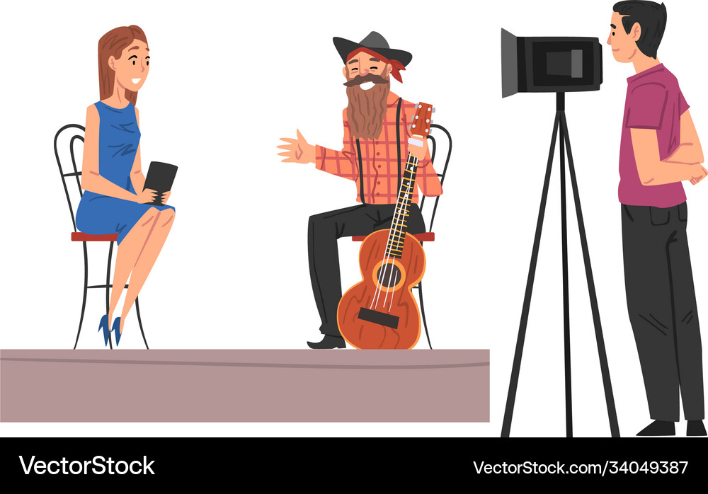 Journalist taking interview at guest and cameraman