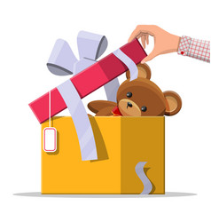 A teddy bear opens a box Royalty Free Vector Image